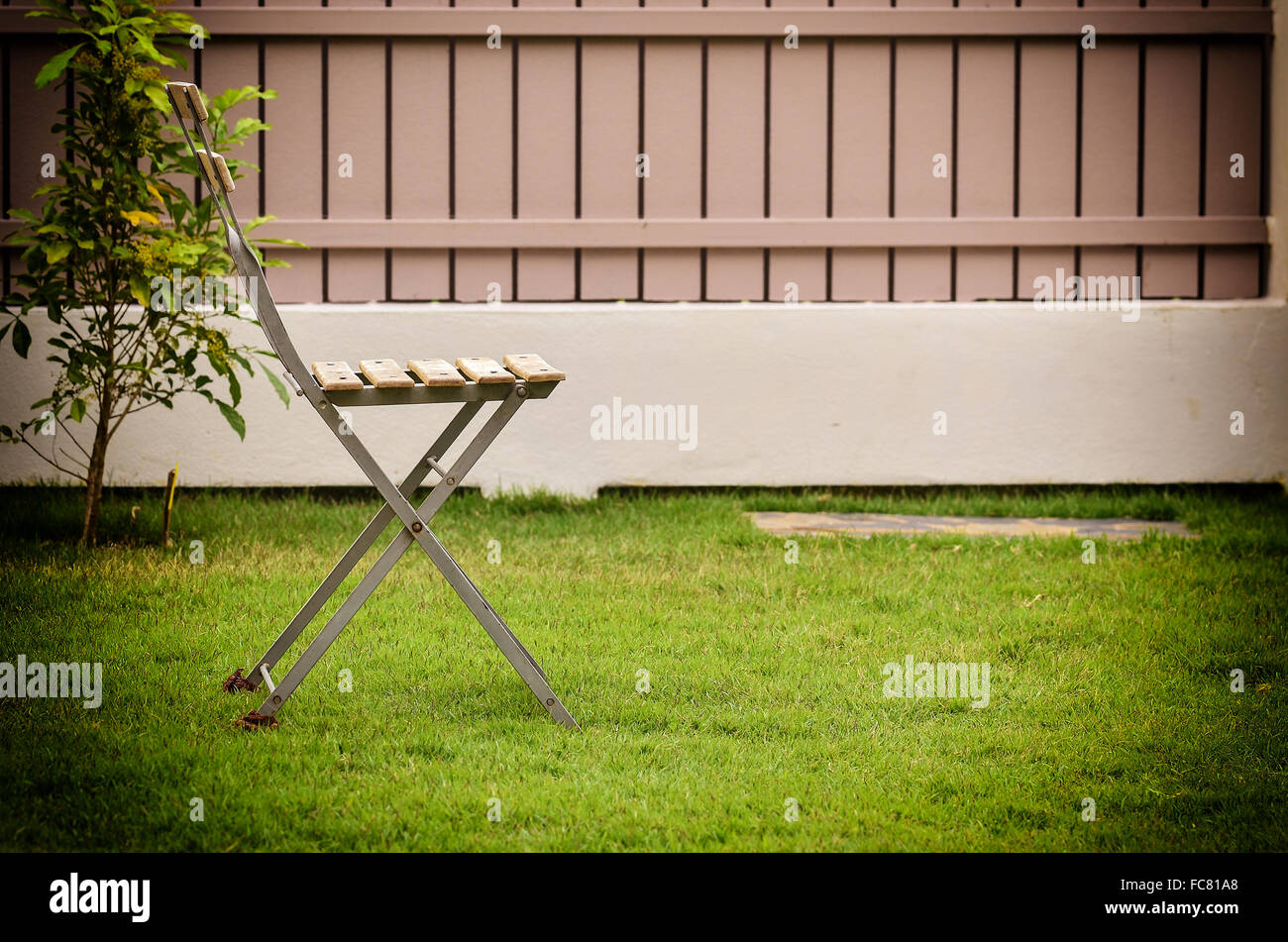 Old chair on green grass in vintage light Stock Photo - Alamy