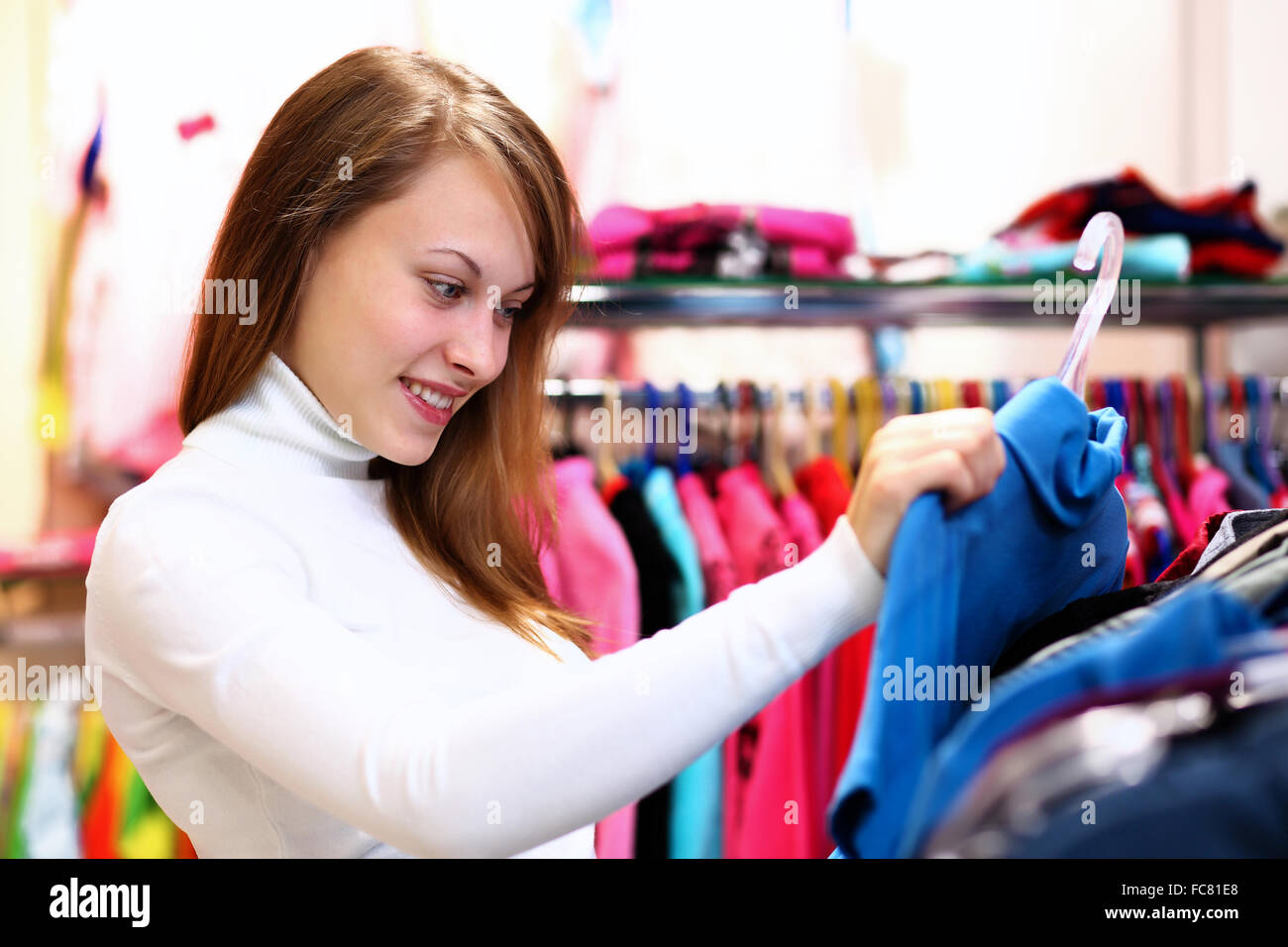Portrait of young woman inside a store buying clothes Stock Photo - Alamy