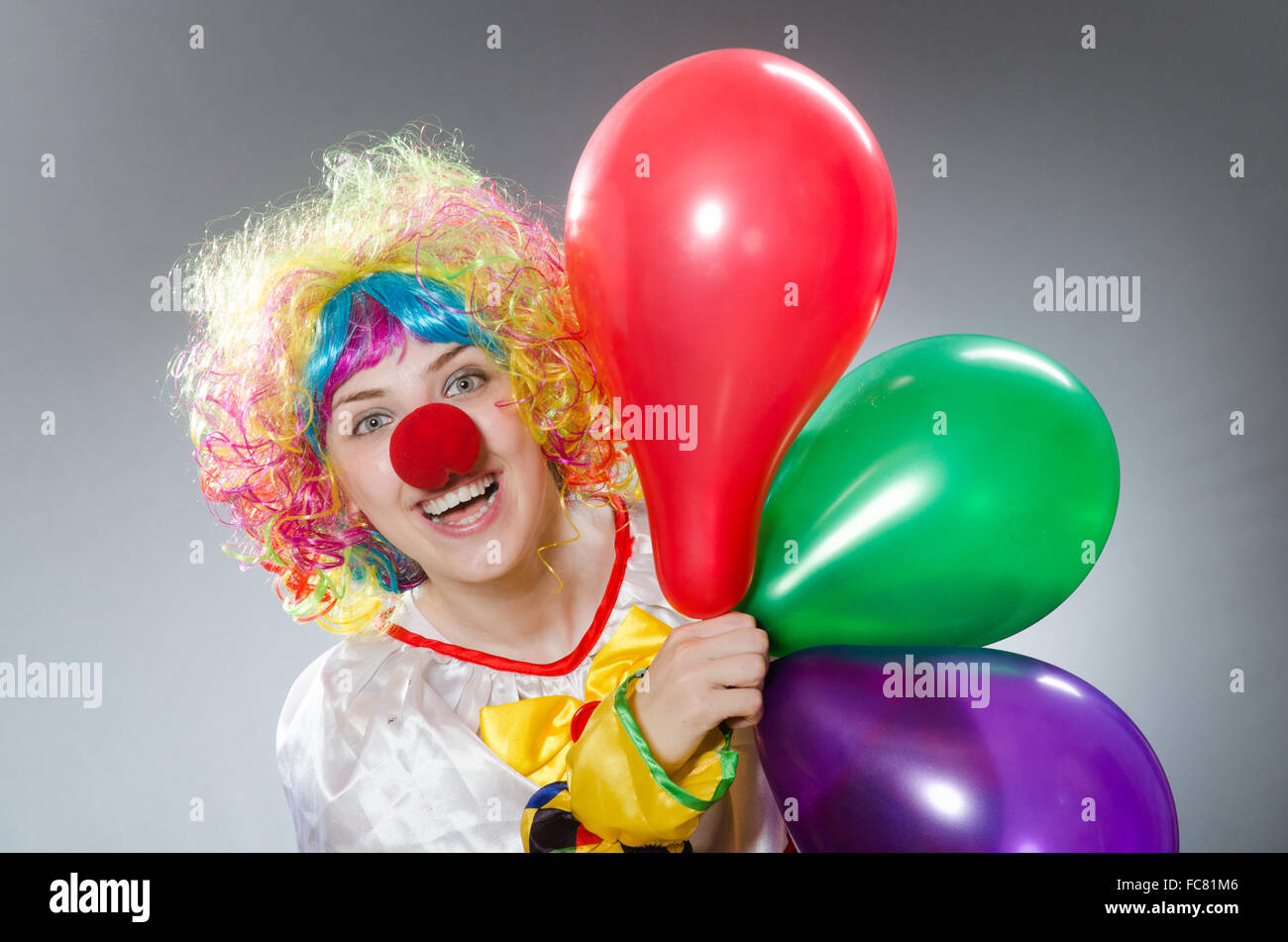 Clown with balloons in funny concept Stock Photo - Alamy