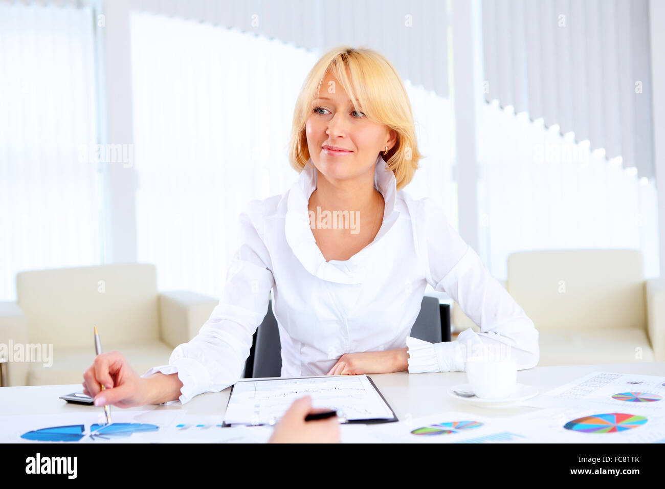 POrtrait of a young beautiful woman in business wear at work Stock ...