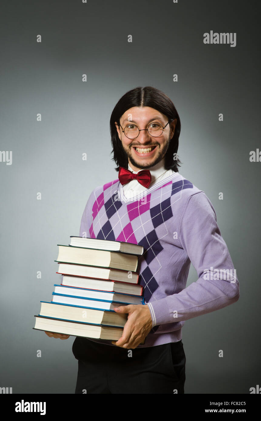 Young student with book in learning concept Stock Photo - Alamy