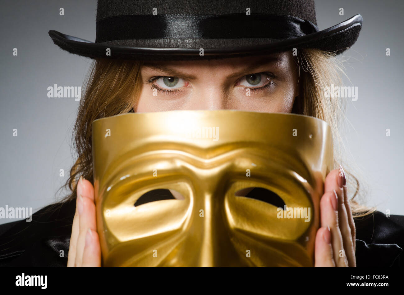 Woman with mask in funny concept Stock Photo - Alamy
