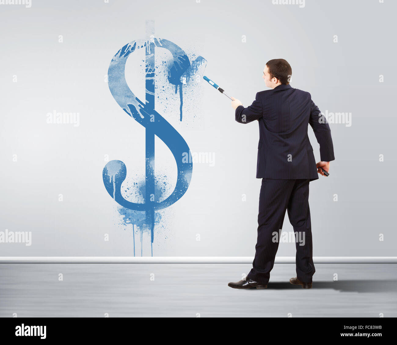 Young man with paint brush and banknote painted on the wall Stock Photo ...