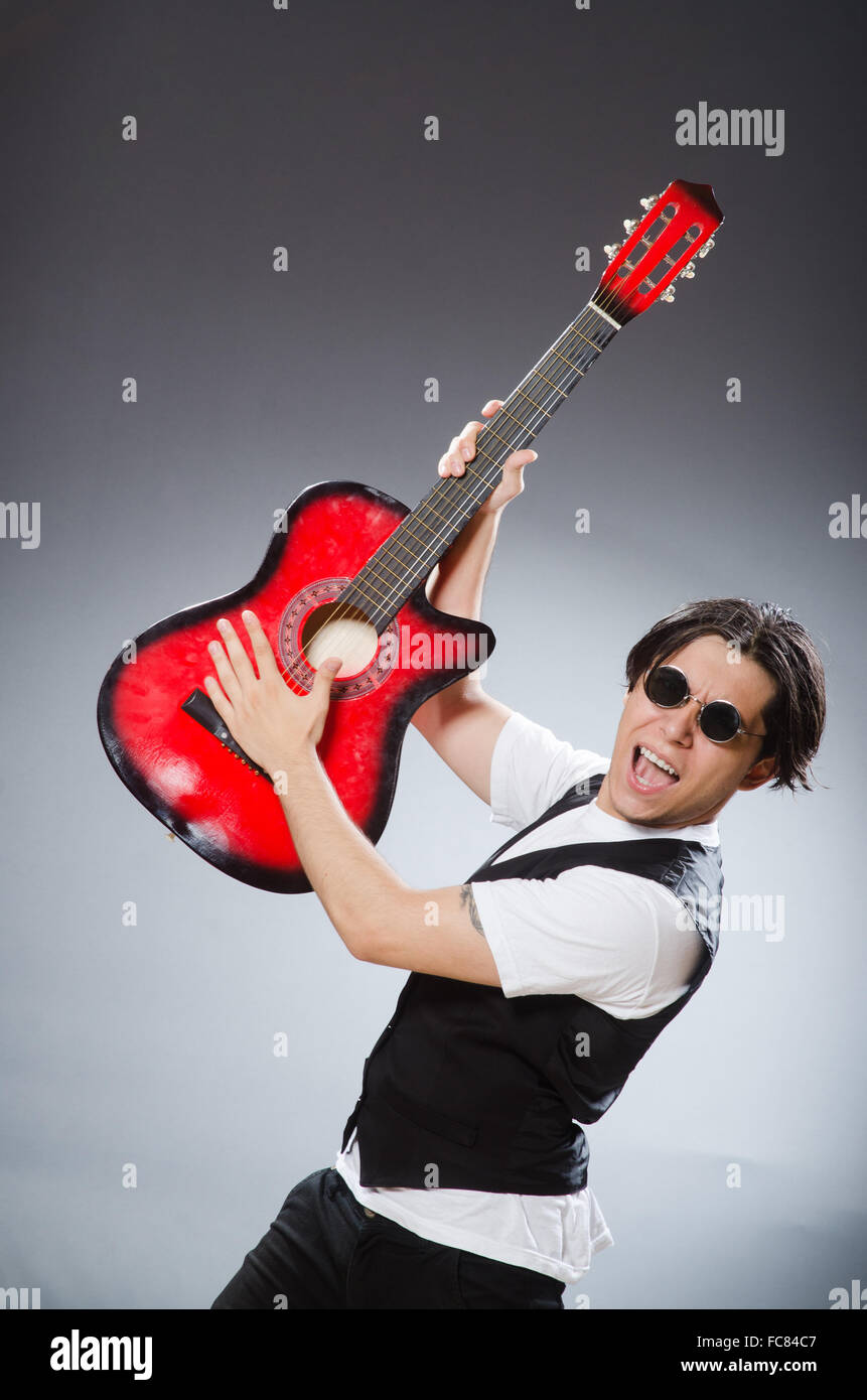 Funny guitar player in musical concept Stock Photo - Alamy