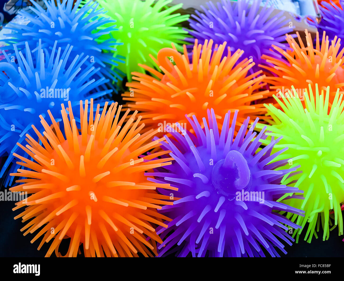 Neon colored small beach balls Stock Photo - Alamy