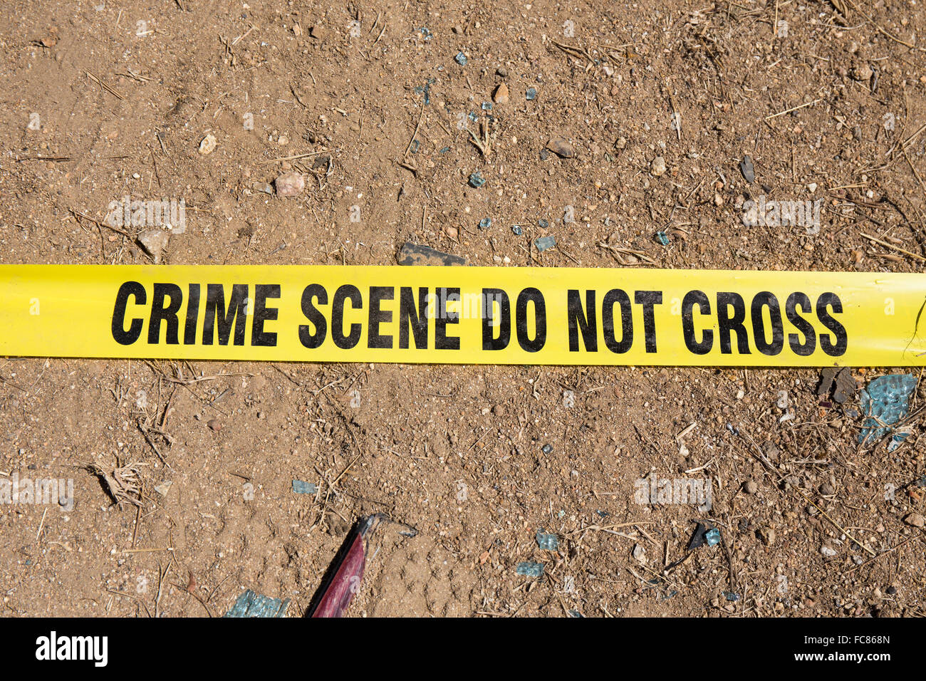 crime scene tape protect the prohibit area on ground with scatter of ...