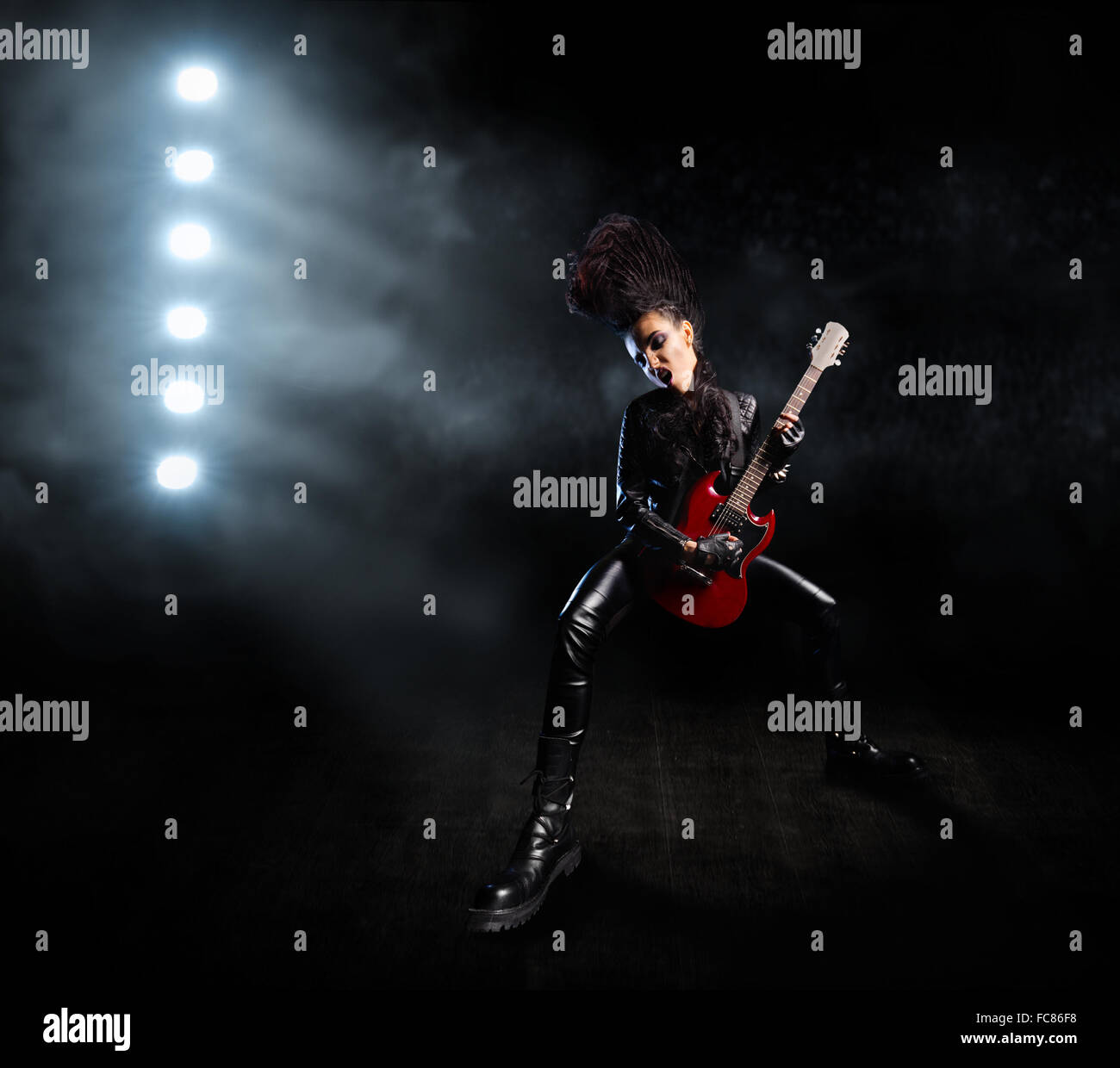 Rock musician in leather clothing on scene Stock Photo - Alamy