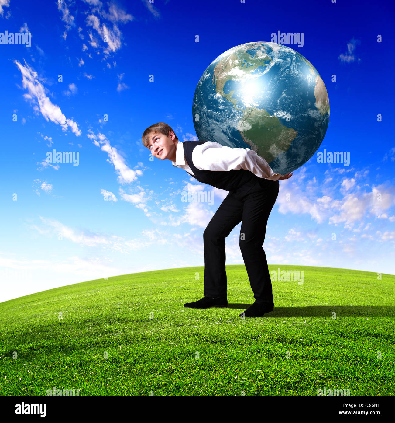 Young businessman carrying world on his back Stock Photo - Alamy