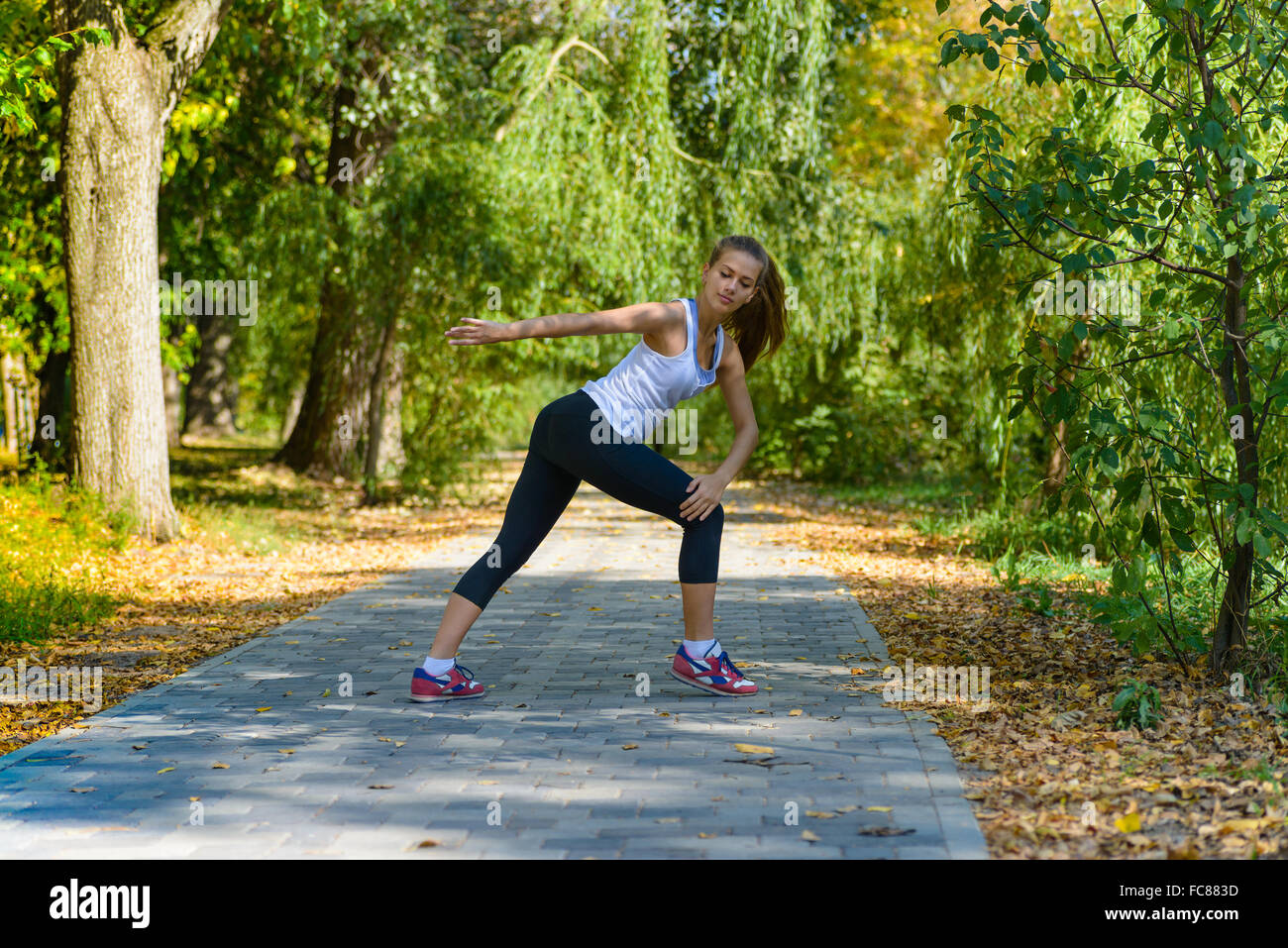 Attractive Woman stretching outdoor Stock Photo - Alamy