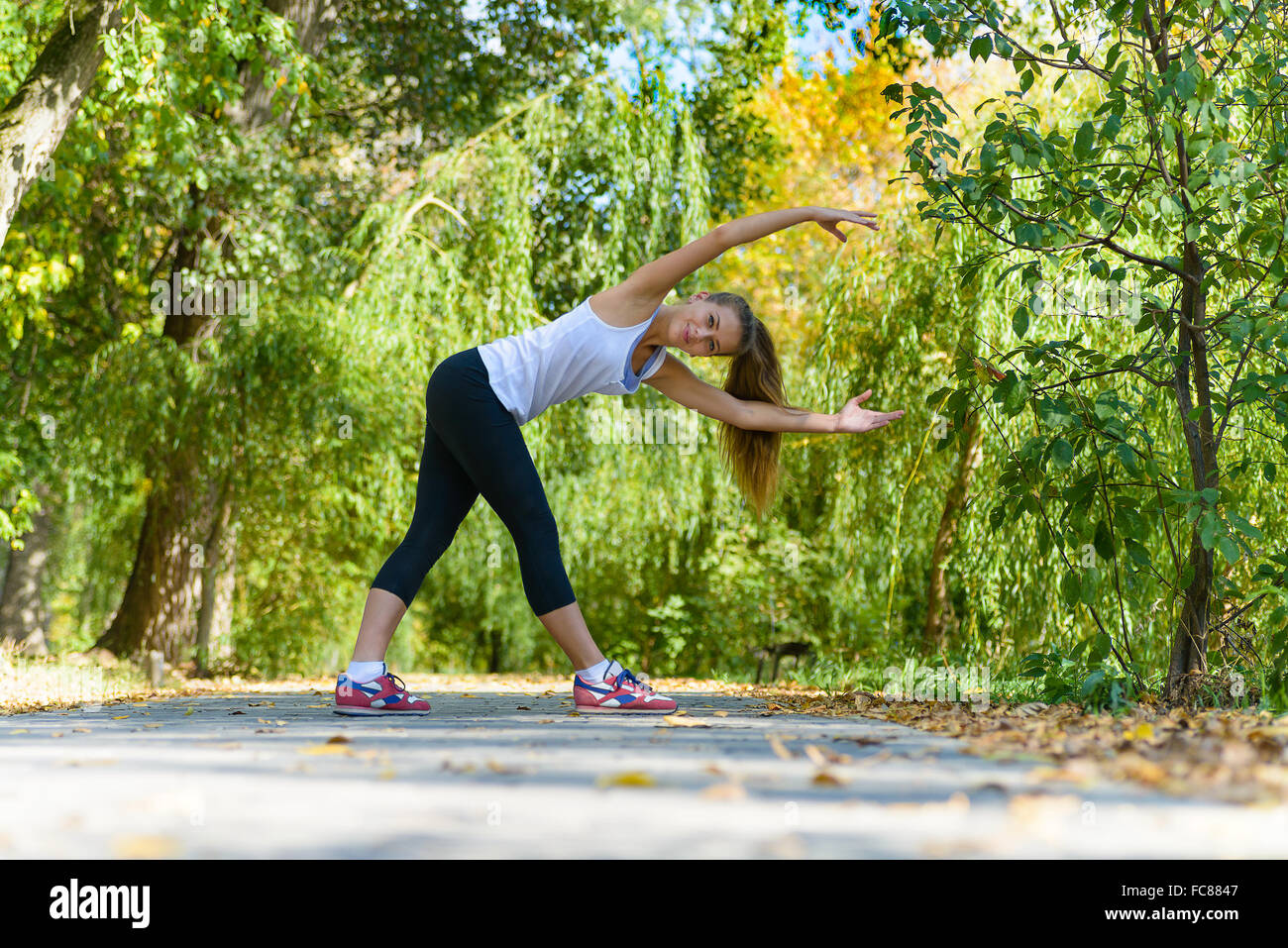 Attractive Woman stretching outdoor Stock Photo - Alamy