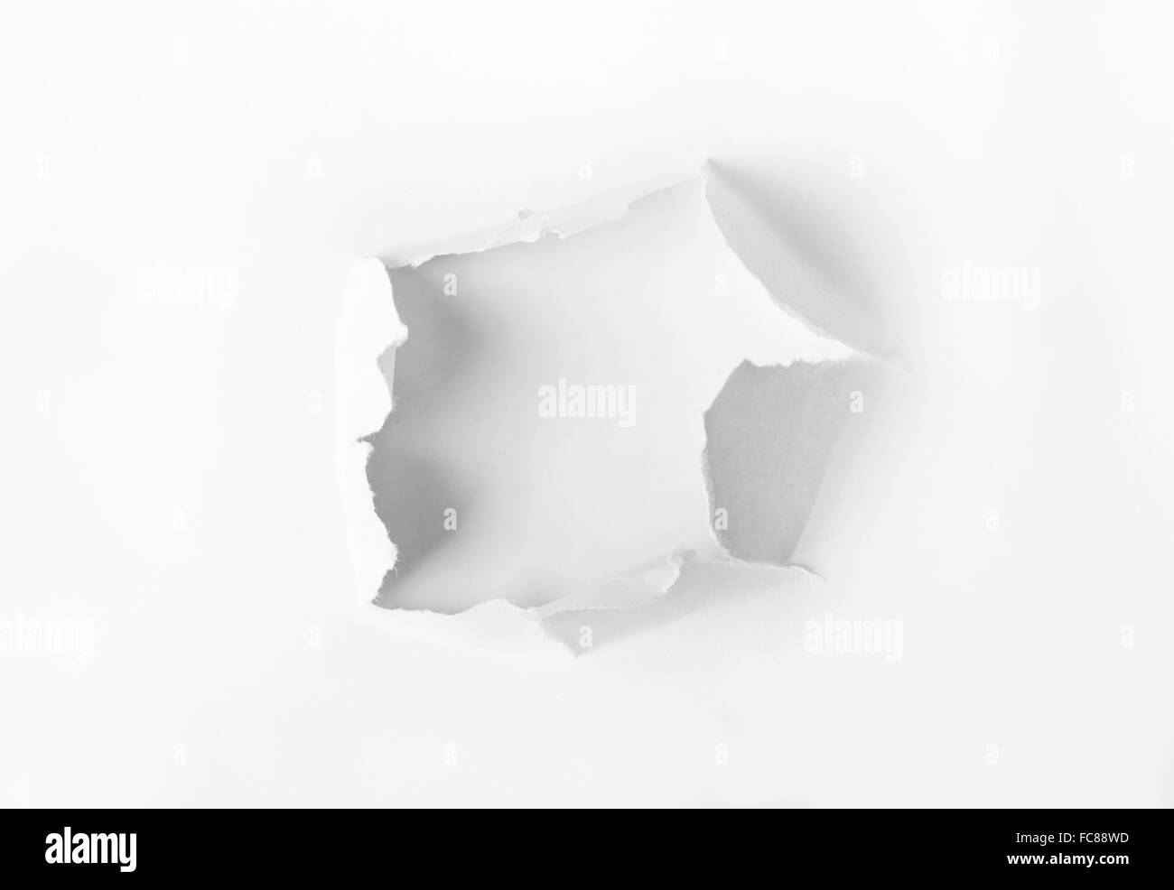 Hole punched in the paper Stock Photo - Alamy