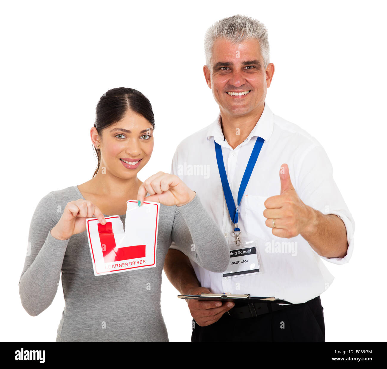 happy driving instructor giving thumb up and learner driver tearing L ...