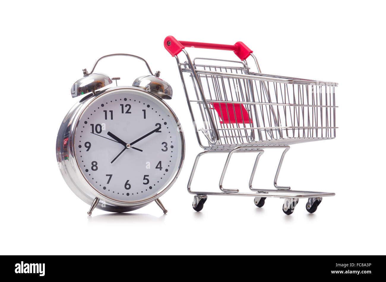 Big alarm clock in shopping cart on white Stock Photo - Alamy