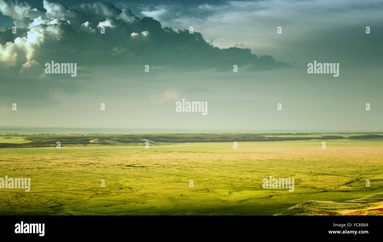 Vast valley in nature with a very dramatic cloud filled sky. The ...