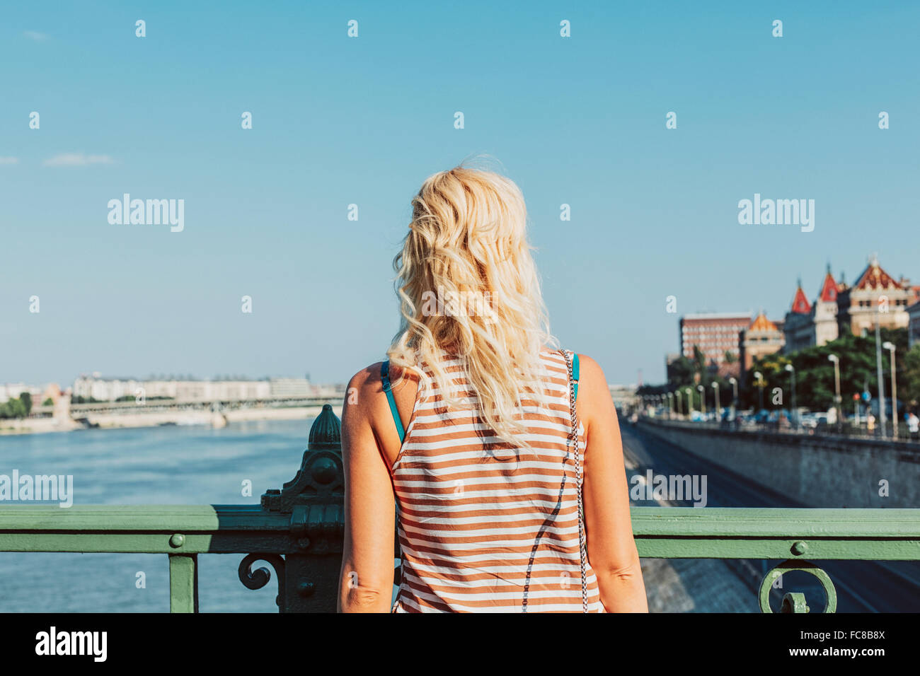 Caucasian woman standing on bridge Stock Photo - Alamy