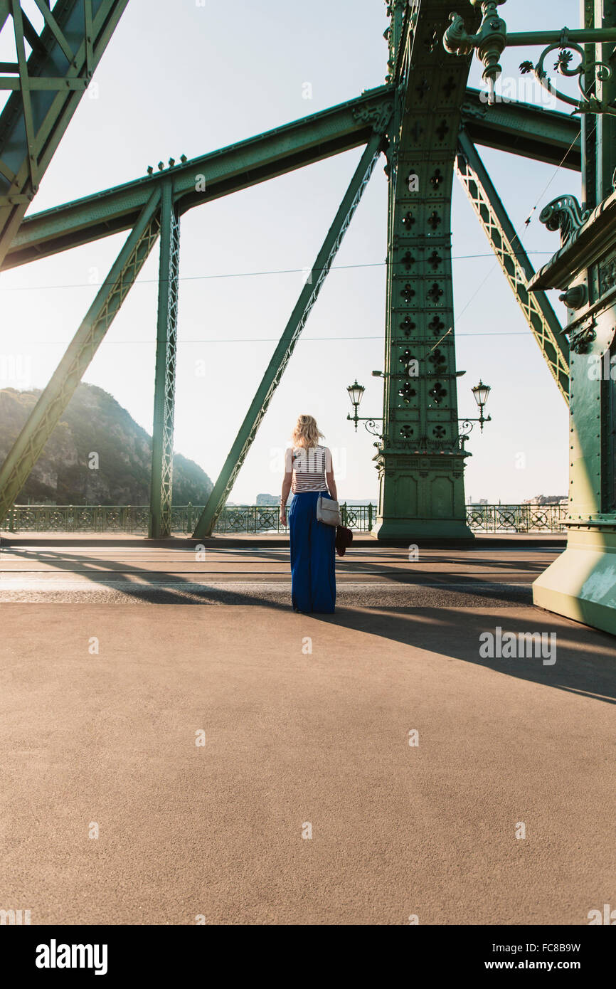 Caucasian woman standing on bridge Stock Photo - Alamy