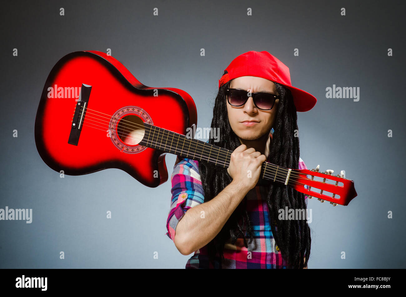 Funny man playing guitar in musical concept Stock Photo - Alamy
