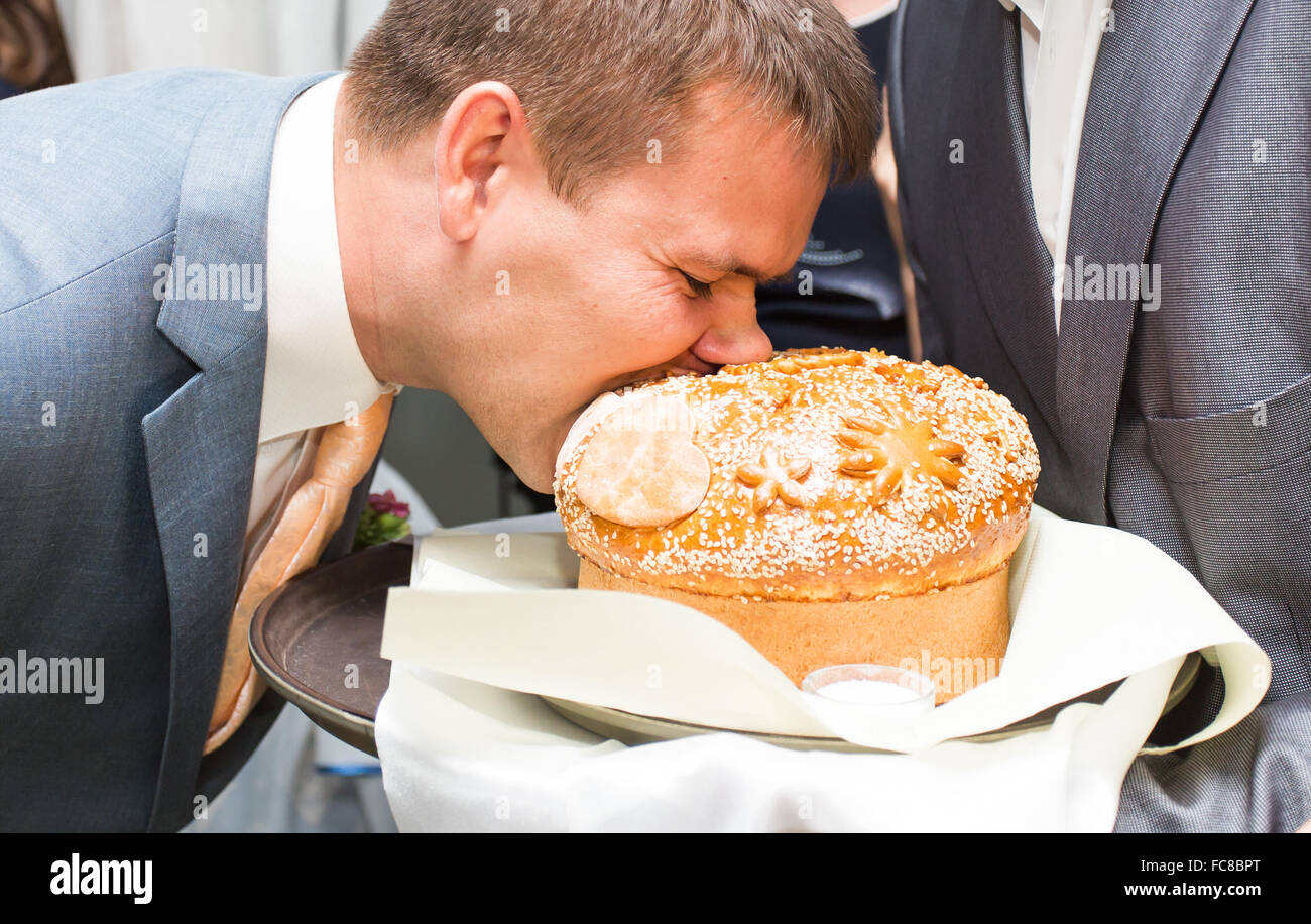 traditional wedding custom to bite a large piece of bread Stock Photo ...