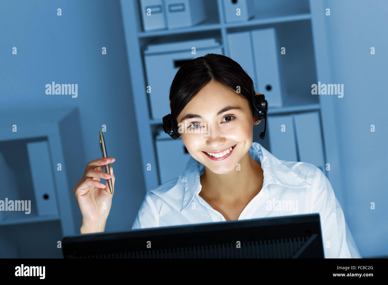 Young woman in business wear in headset working with computer Stock ...