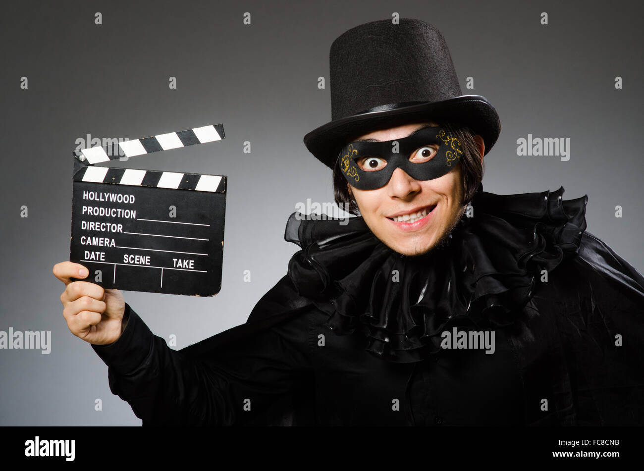 Man wearing mask with movie board Stock Photo - Alamy