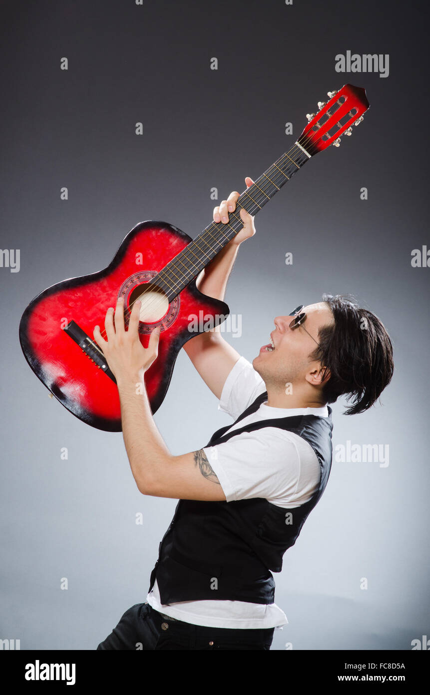 Funny guitar player in musical concept Stock Photo - Alamy