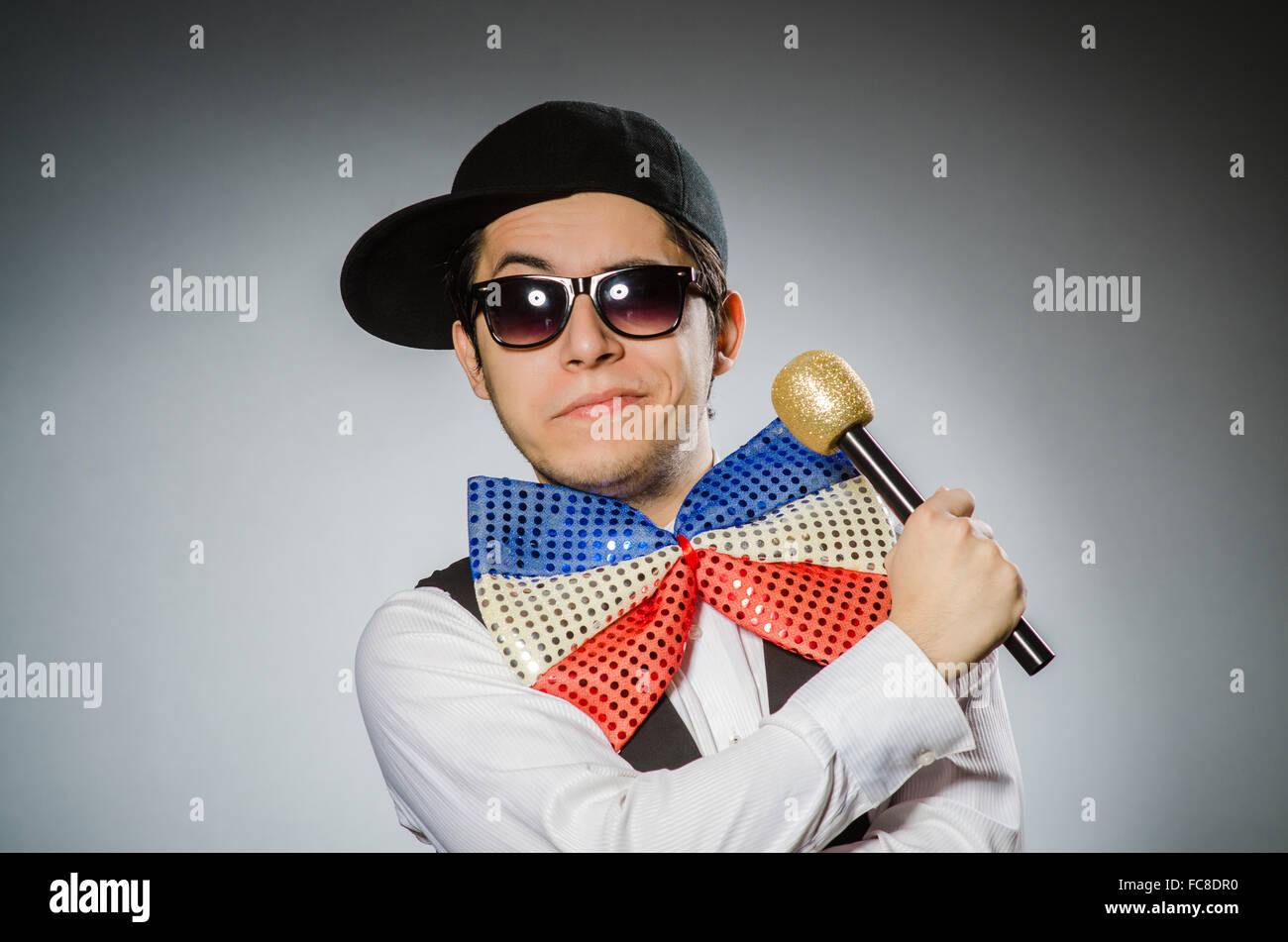 Funny man with mic in karaoke concept Stock Photo - Alamy
