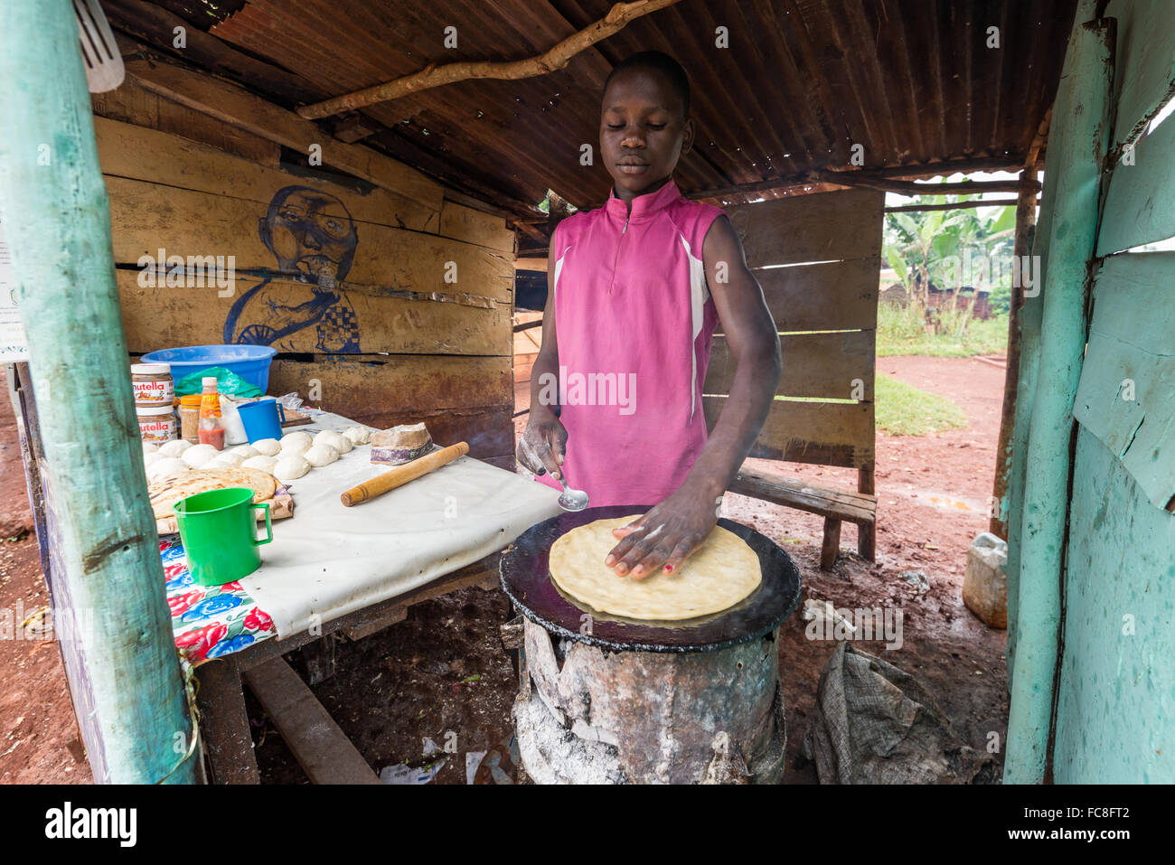 A young man makes chapattis in the Jinja, Uganda, Africa Stock Photo ...
