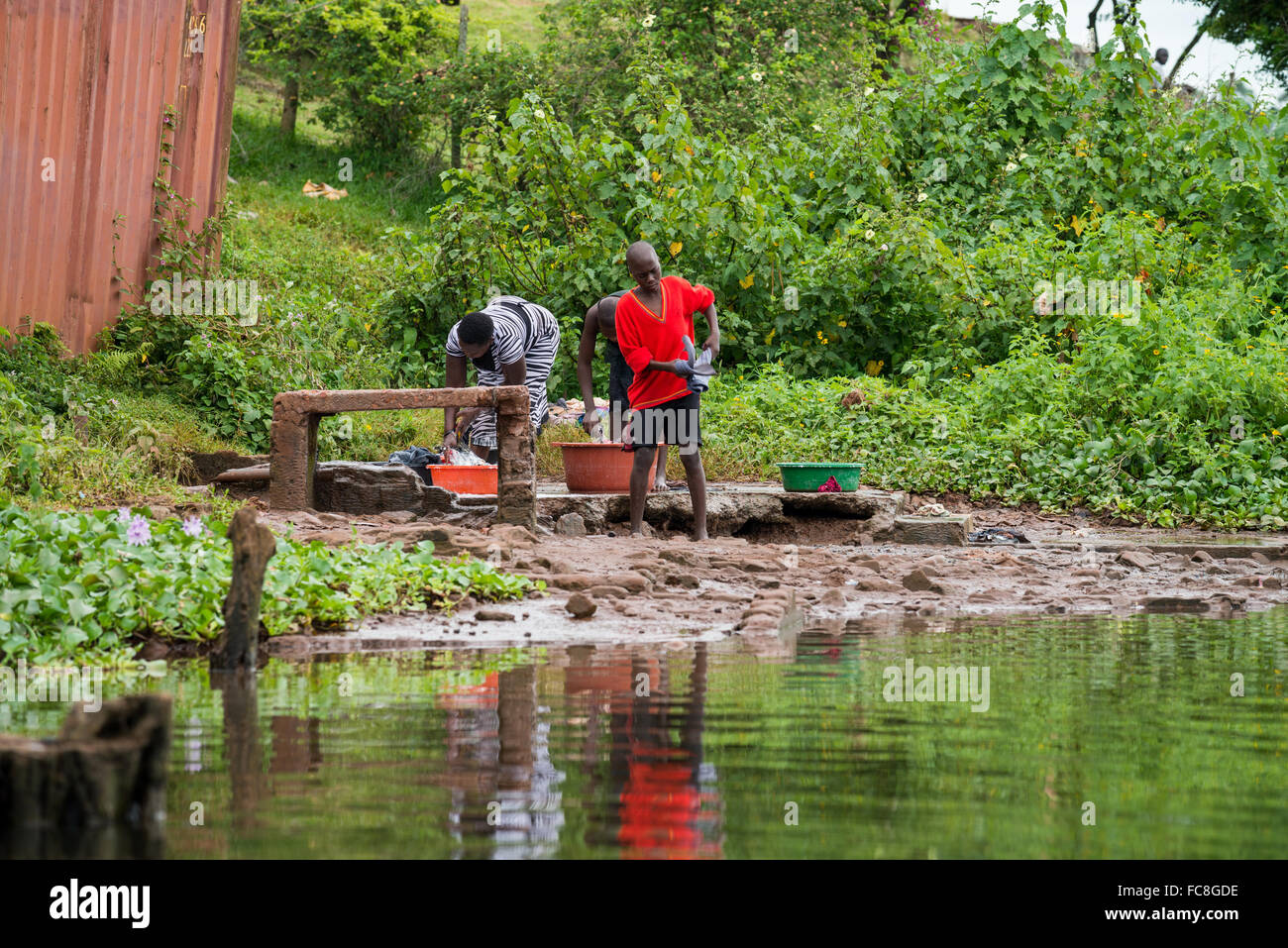 Local villagers washing and drying clothes by the river in Jinja ...