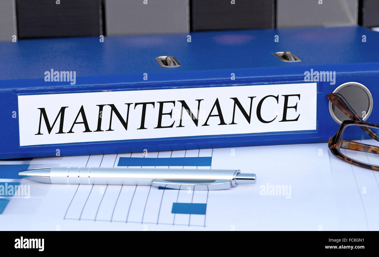 Maintenance - blue binder in the office Stock Photo - Alamy
