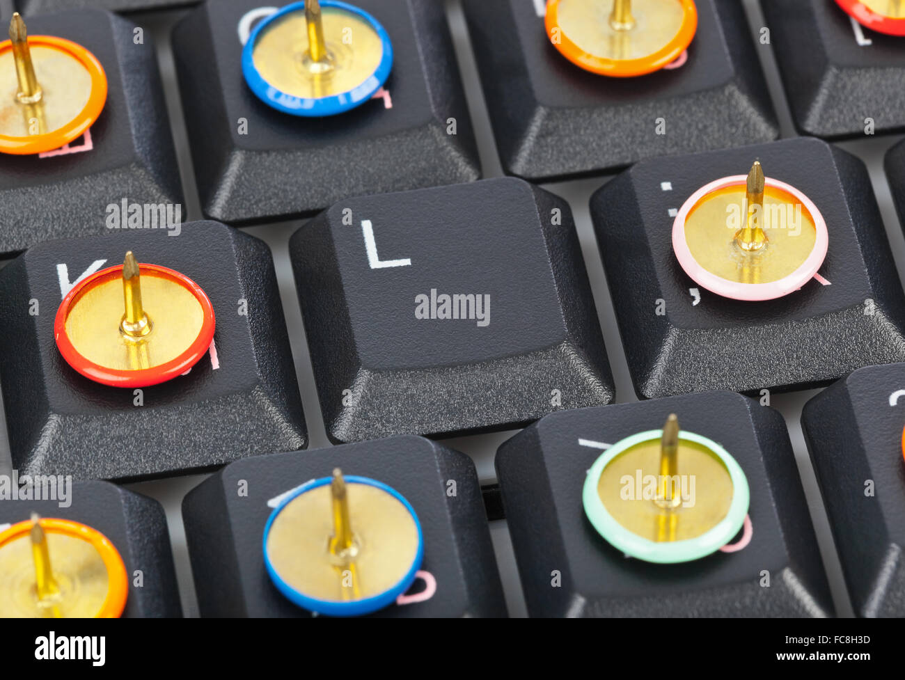 Pins on computer keyboard Stock Photo - Alamy