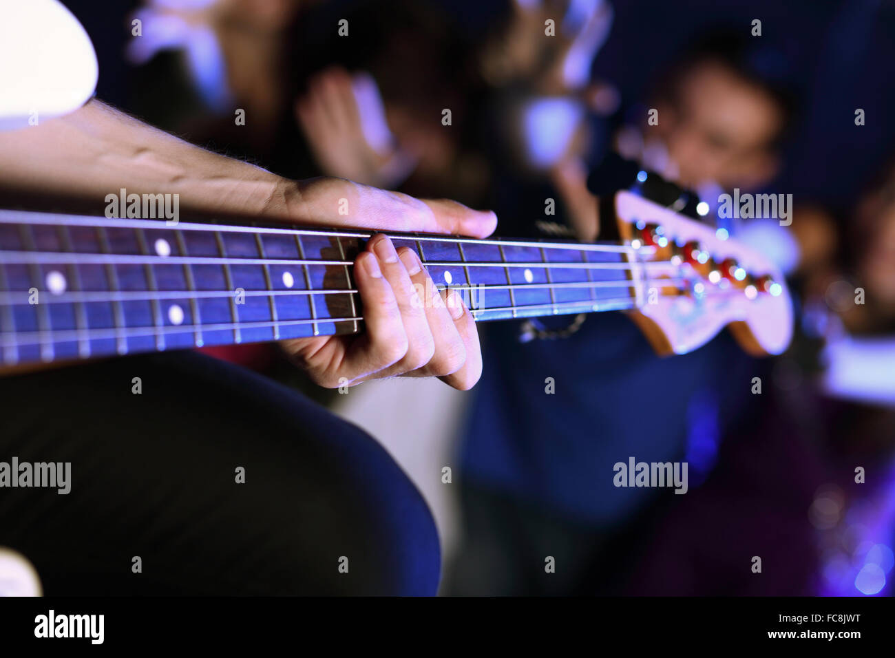 Young guitar player with instrument performing in night club Stock ...