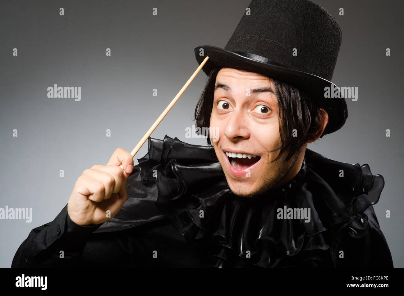 Funny magician wearing cylinder hat Stock Photo - Alamy