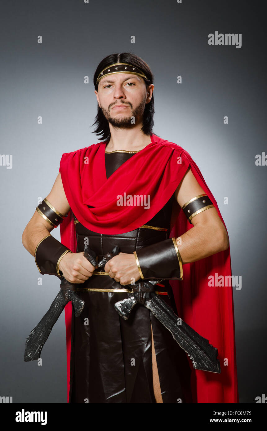 Roman warrior with sword against background Stock Photo - Alamy