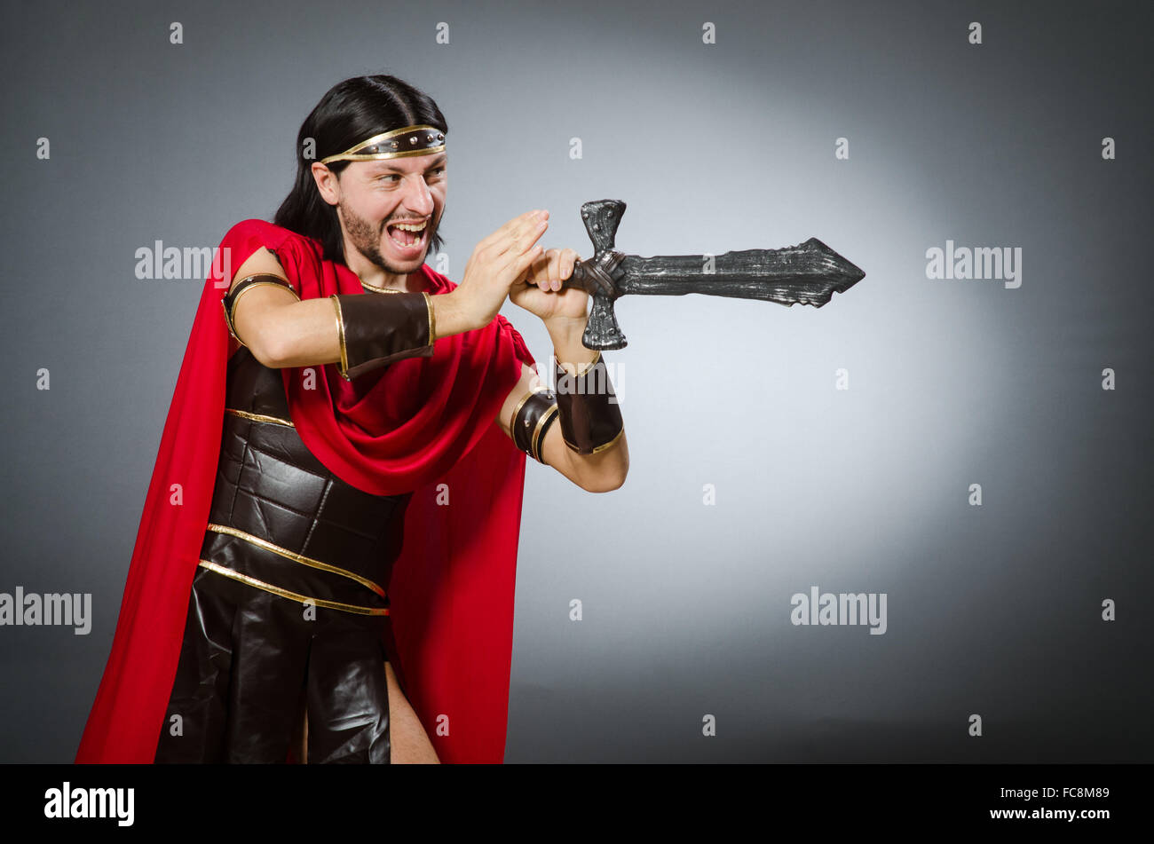 Roman warrior with sword against background Stock Photo - Alamy