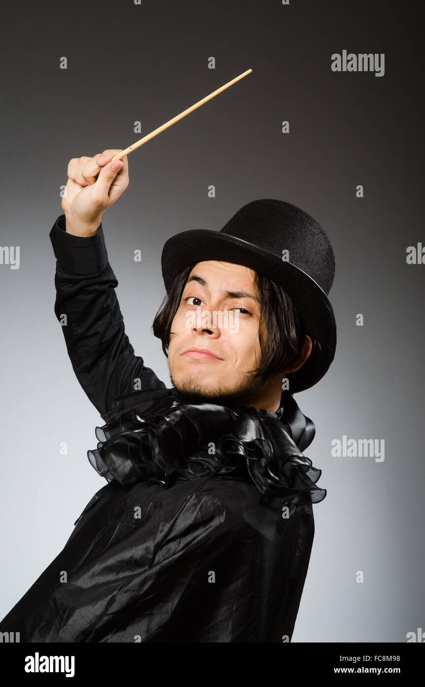 Funny magician wearing cylinder hat Stock Photo - Alamy