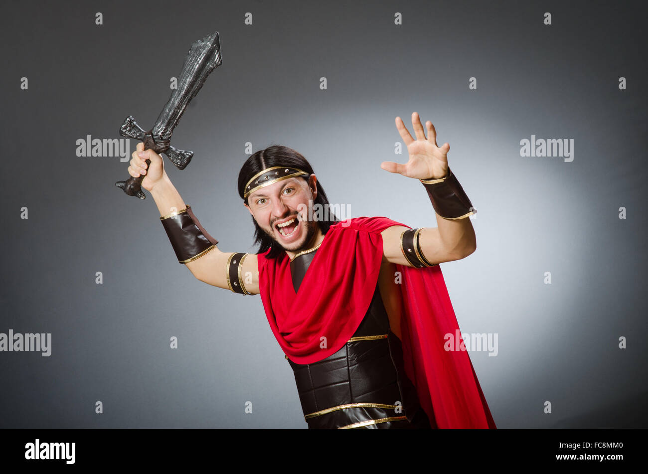 Roman warrior with sword against background Stock Photo - Alamy