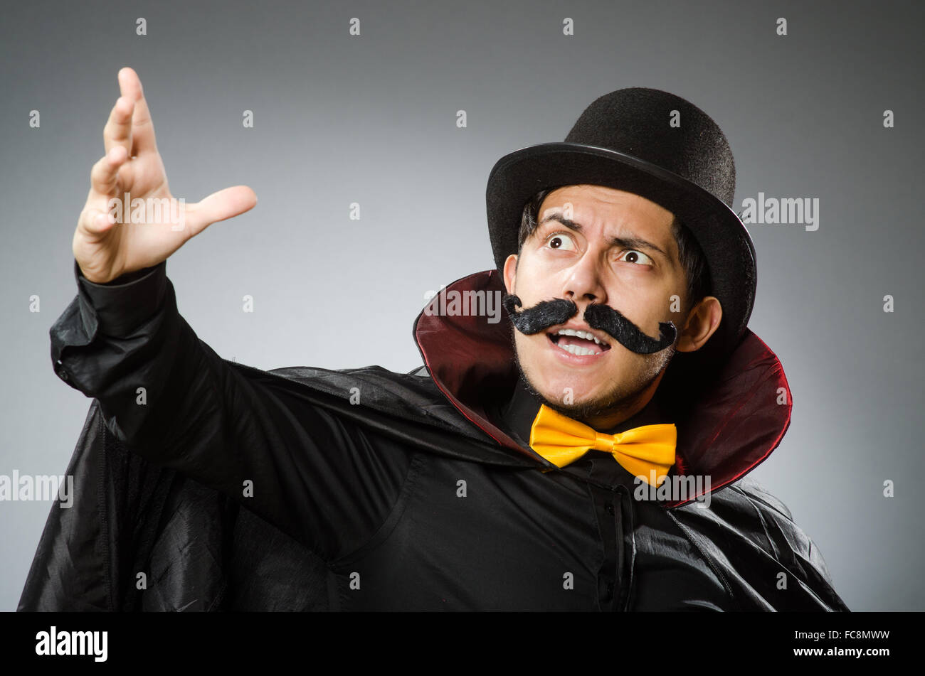 Funny magician man wearing tophat Stock Photo - Alamy
