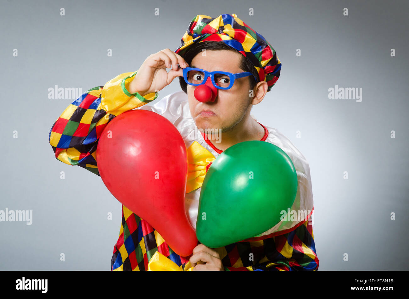 Clown with balloons in funny concept Stock Photo - Alamy