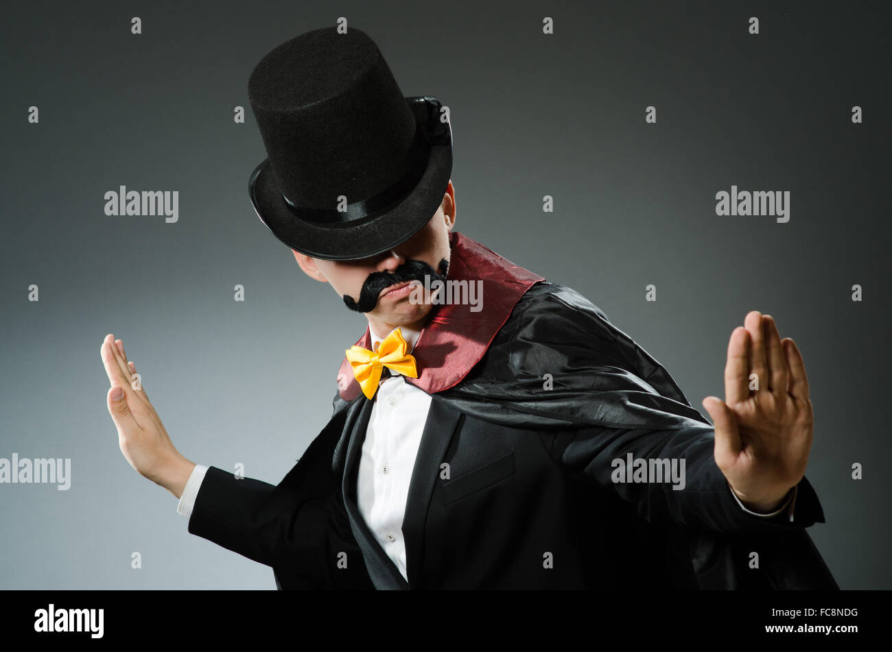Funny magician man wearing tophat Stock Photo - Alamy