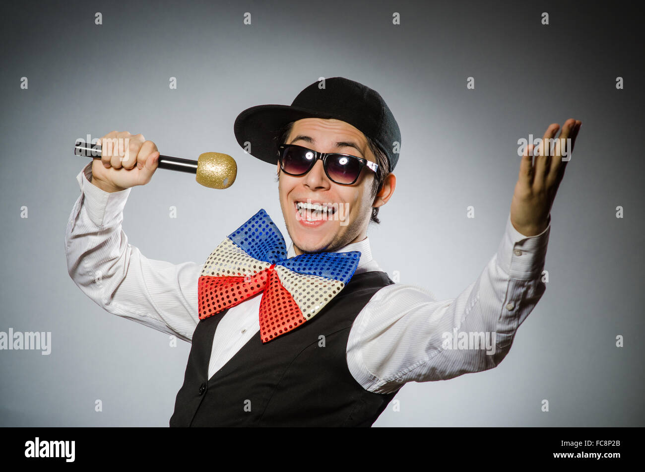 Funny man with mic in karaoke concept Stock Photo - Alamy