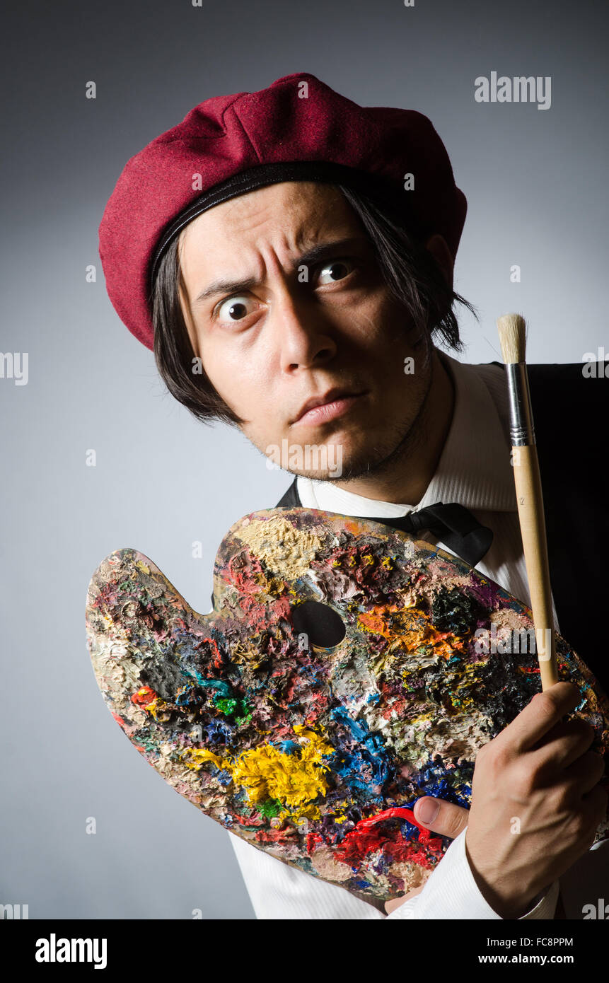 Funny artist in dark studio Stock Photo - Alamy