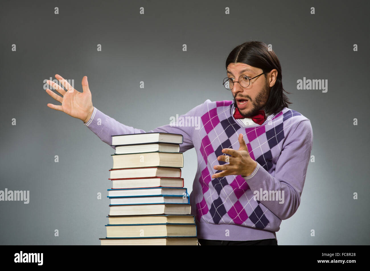 Young student with book in learning concept Stock Photo - Alamy