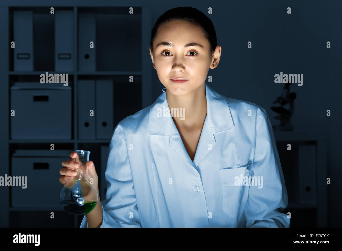 Young chemist in white uniform working in laboratory Stock Photo - Alamy