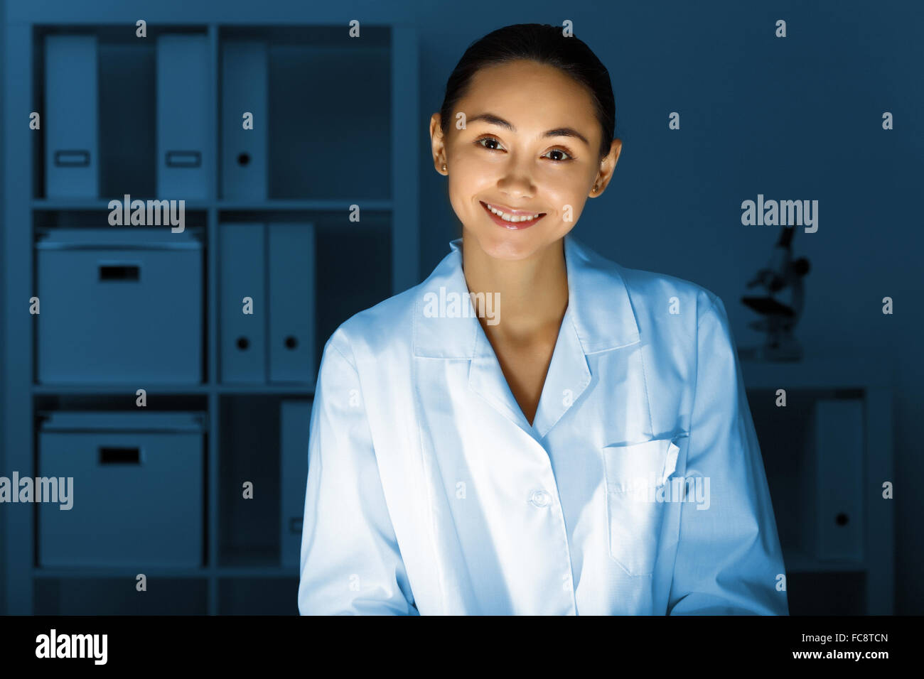 Young chemist in white uniform working in laboratory Stock Photo - Alamy
