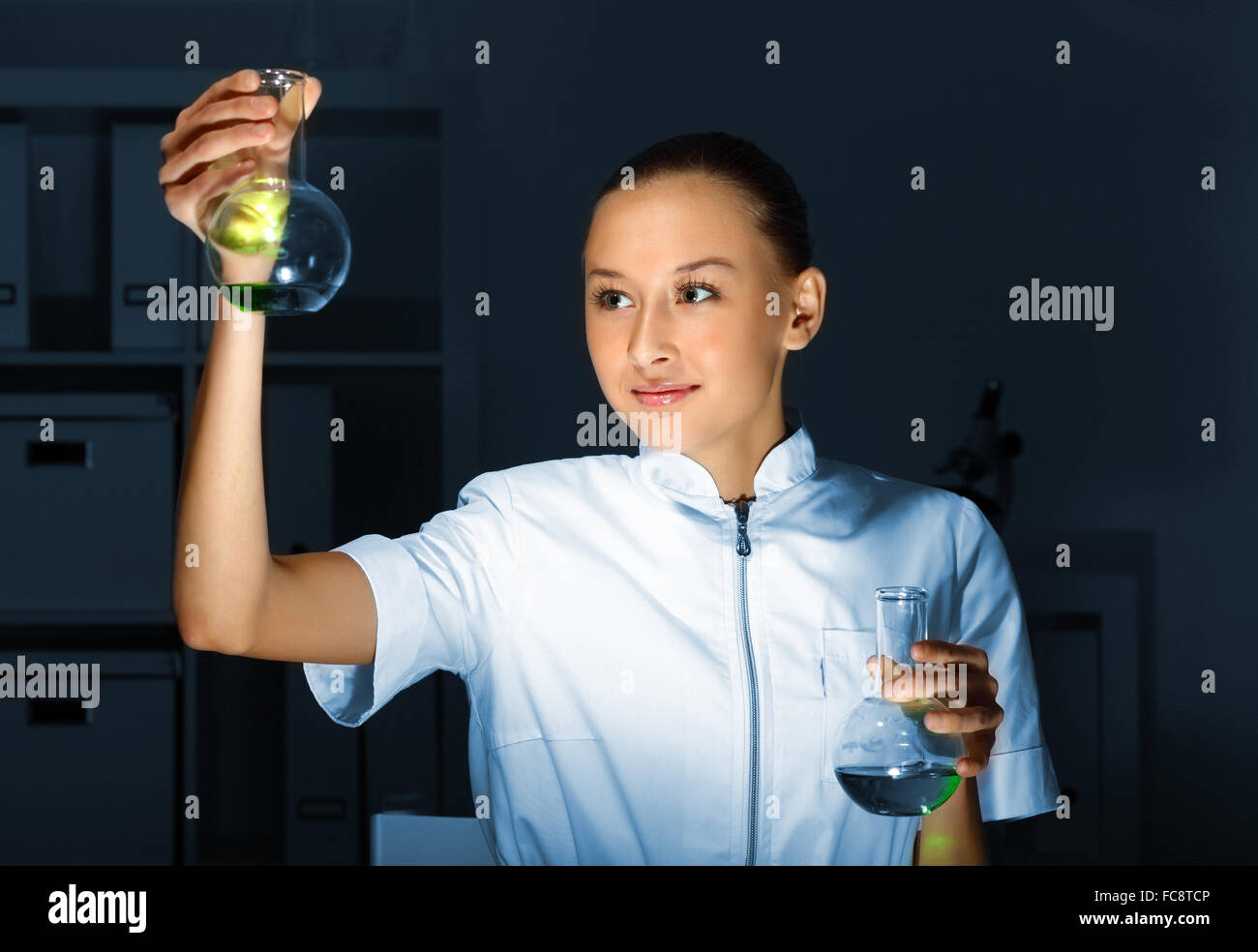 Young chemist in white uniform working in laboratory Stock Photo - Alamy