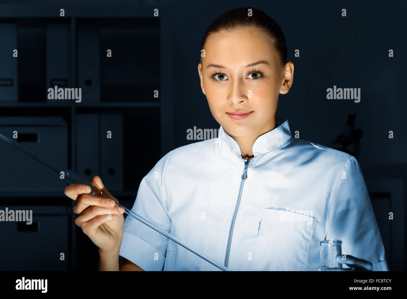 Young chemist in white uniform working in laboratory Stock Photo - Alamy