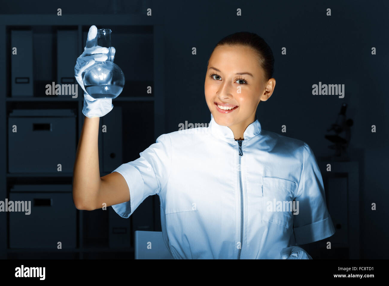 Young chemist in white uniform working in laboratory Stock Photo - Alamy