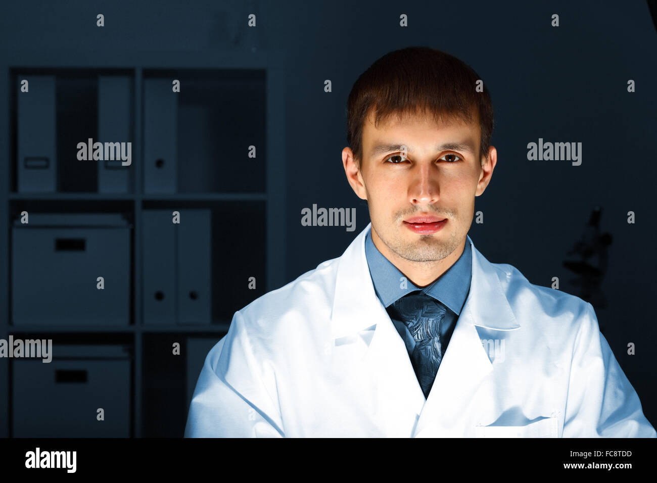 Young chemist in white uniform working in laboratory Stock Photo - Alamy