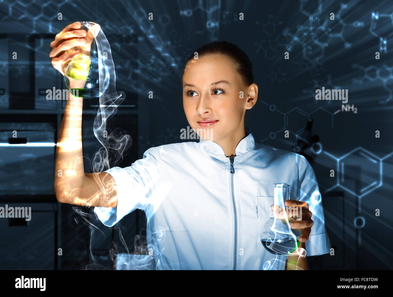 Young chemist in white uniform working in laboratory Stock Photo - Alamy