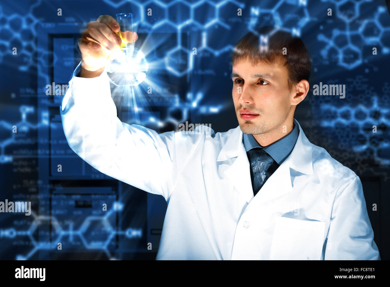 Young chemist in white uniform working in laboratory Stock Photo - Alamy